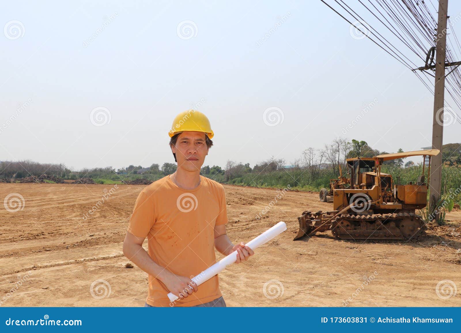 Male Civil Engineer Wear Yellow Helmet and Project Drafts while in Hand ...
