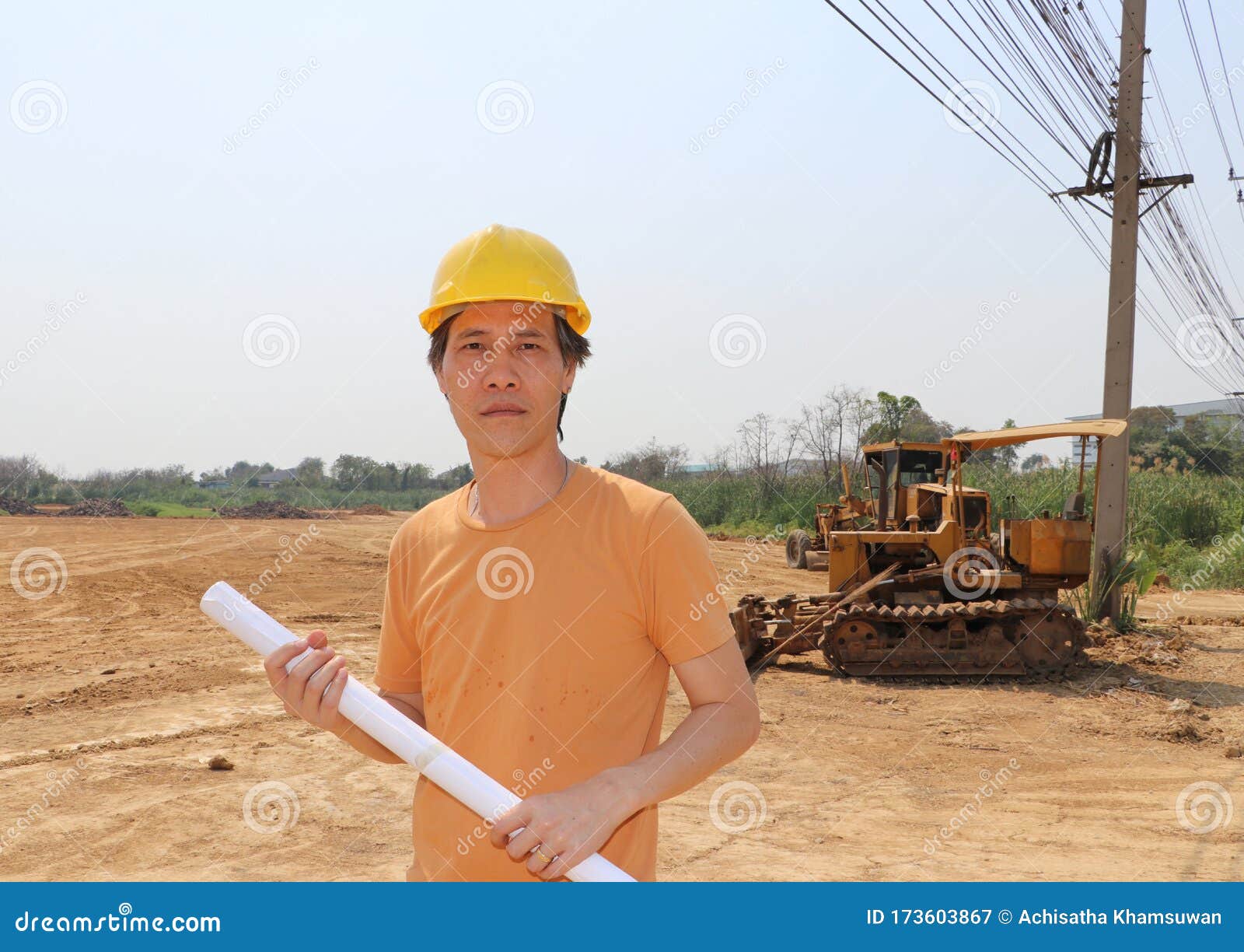 Male Civil Engineer Wear Yellow Helmet and Project Drafts while in Hand ...