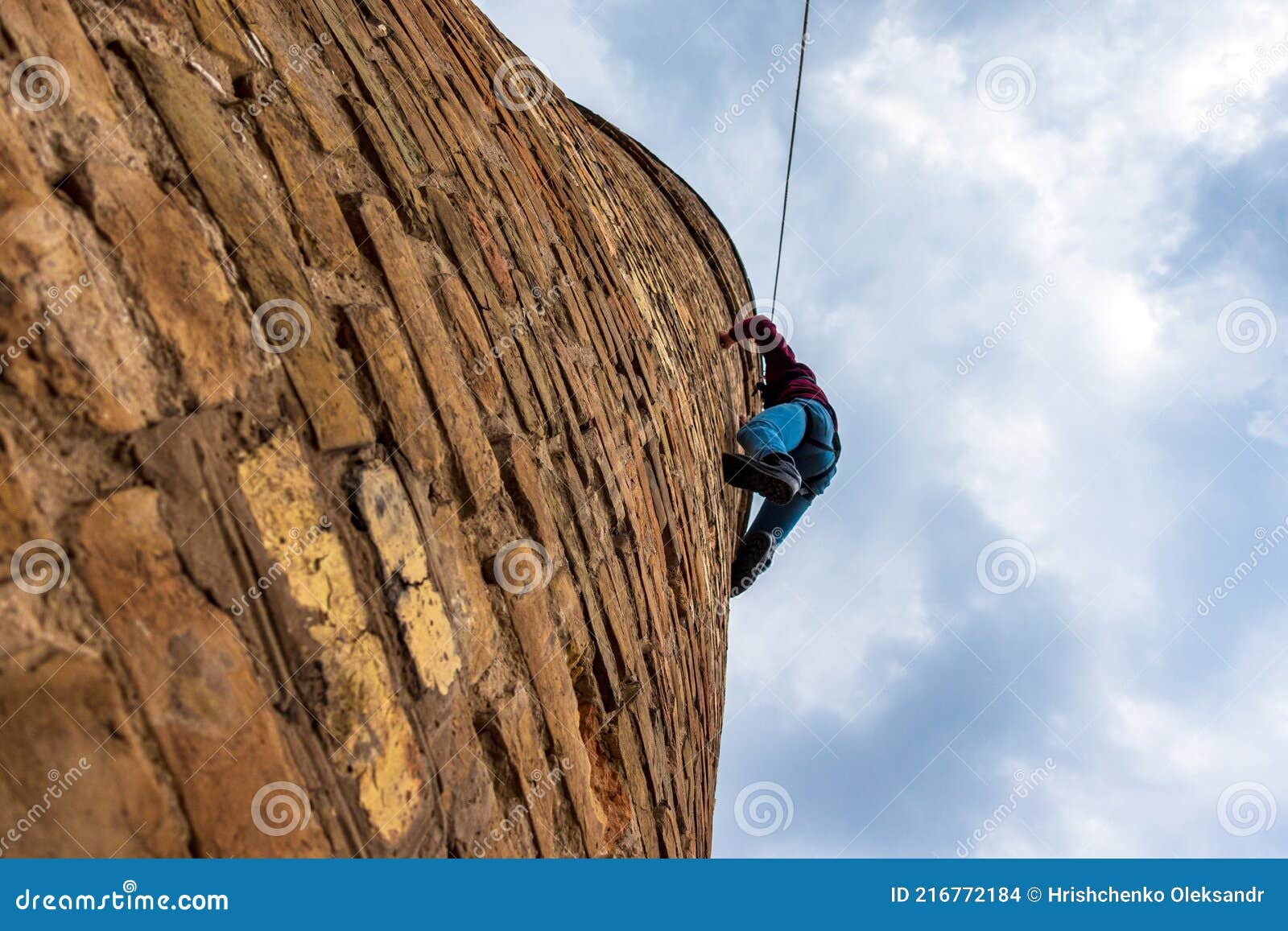 A Male Climber Climbs a Brick Water Tower Stock Photo - Image of ...