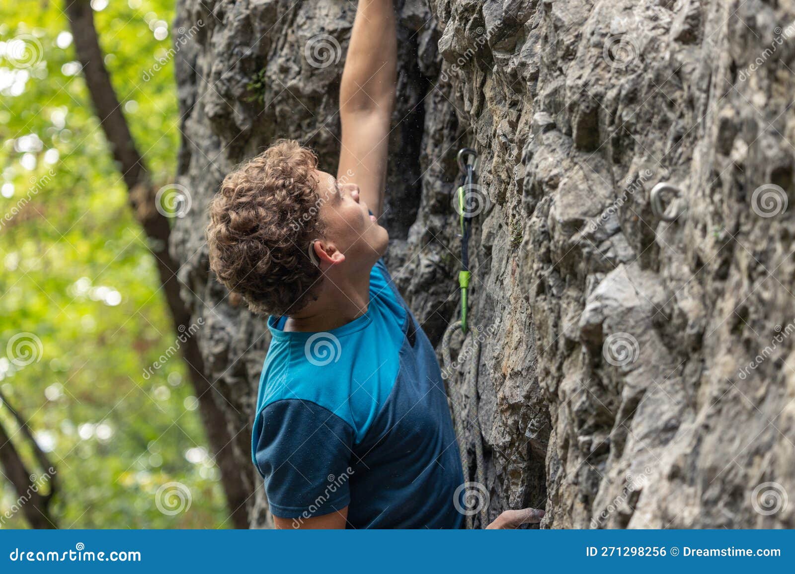 Male Climber Reaching Up while Ascending the Rock Wall Stock Photo ...