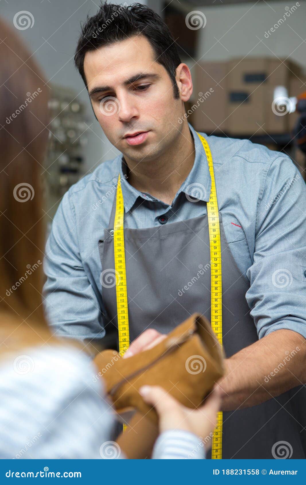 Male cobbler with customer stock photo. Image of leather - 188231558