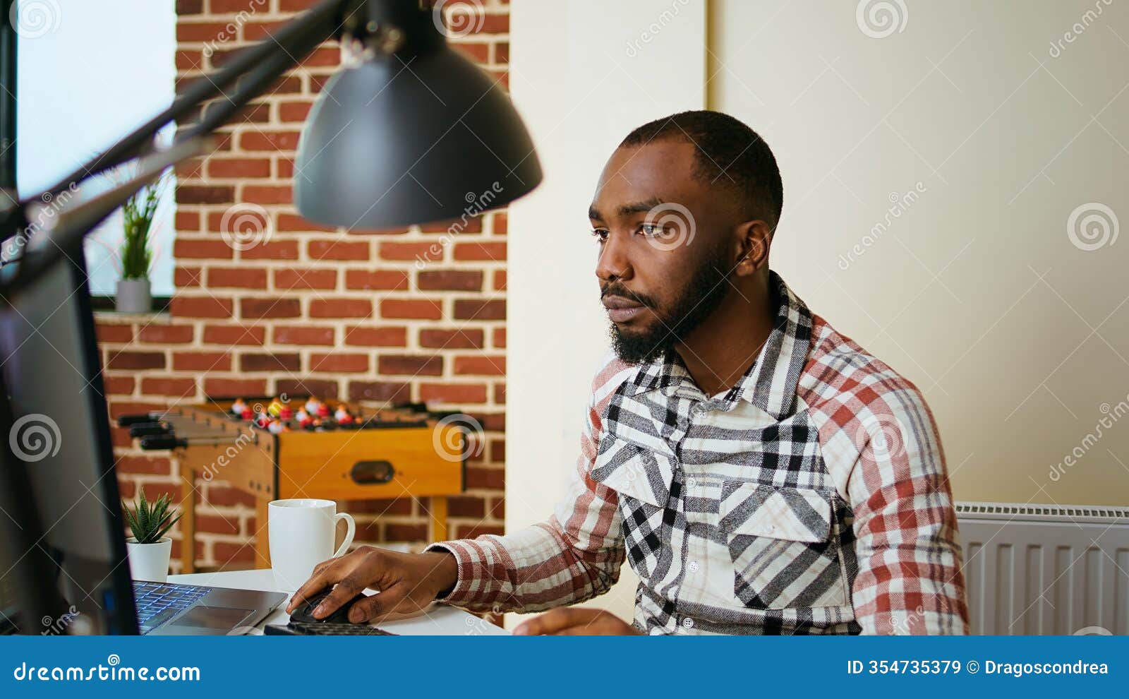 Male Coder Works from Home Typing Code on a Laptop in a Modern Living ...