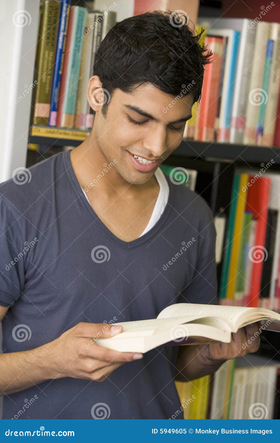 Male College Student Reading in a Library Stock Image - Image of ...