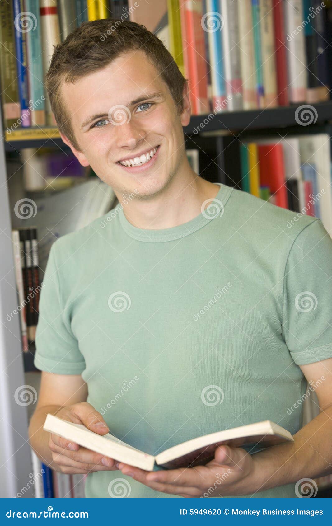 Male College Student Reading in a Library Stock Photo - Image of color ...