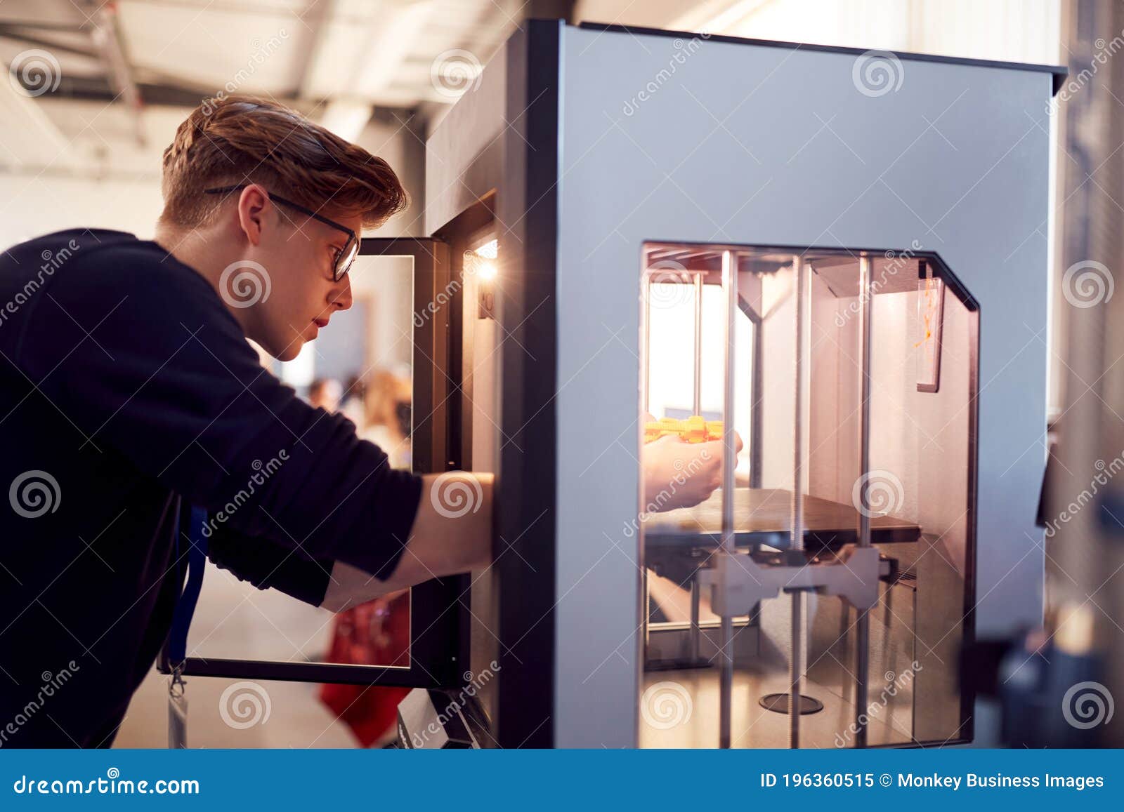 Male College Student Studying Engineering Using 3D Printing Machine ...