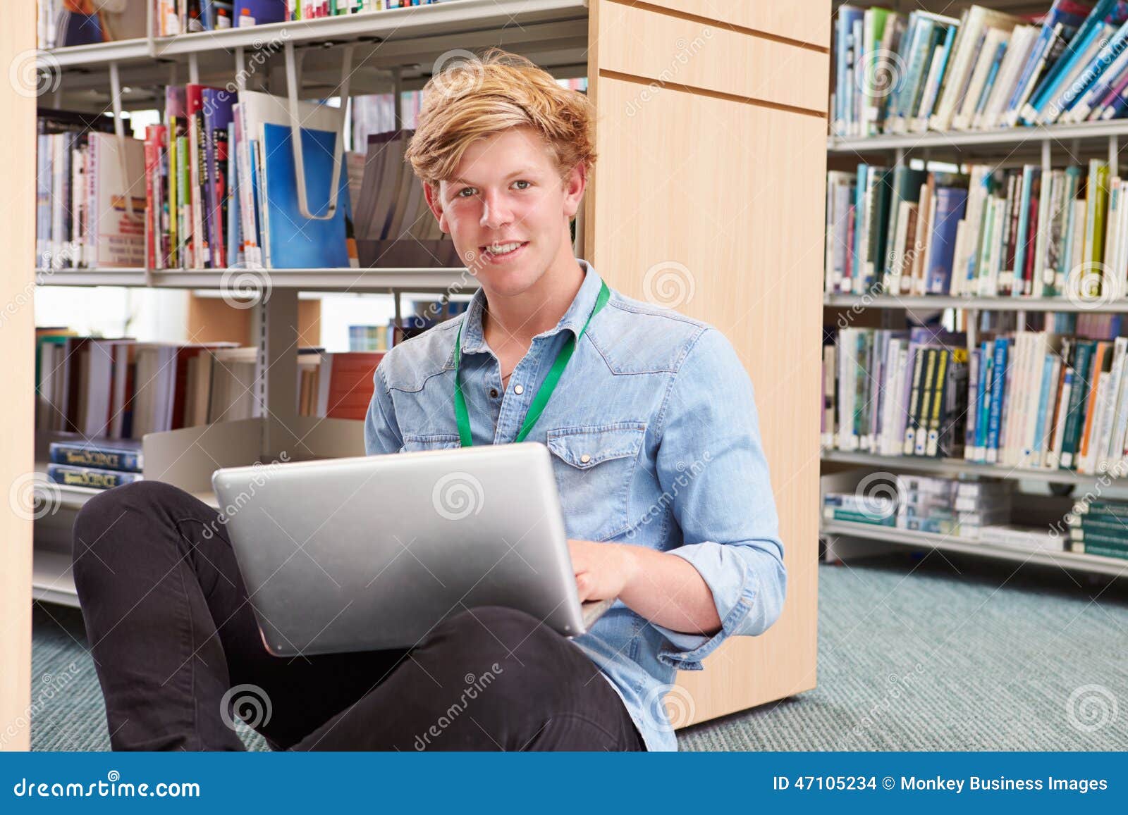 Male College Student Studying in Library with Laptop Stock Photo ...