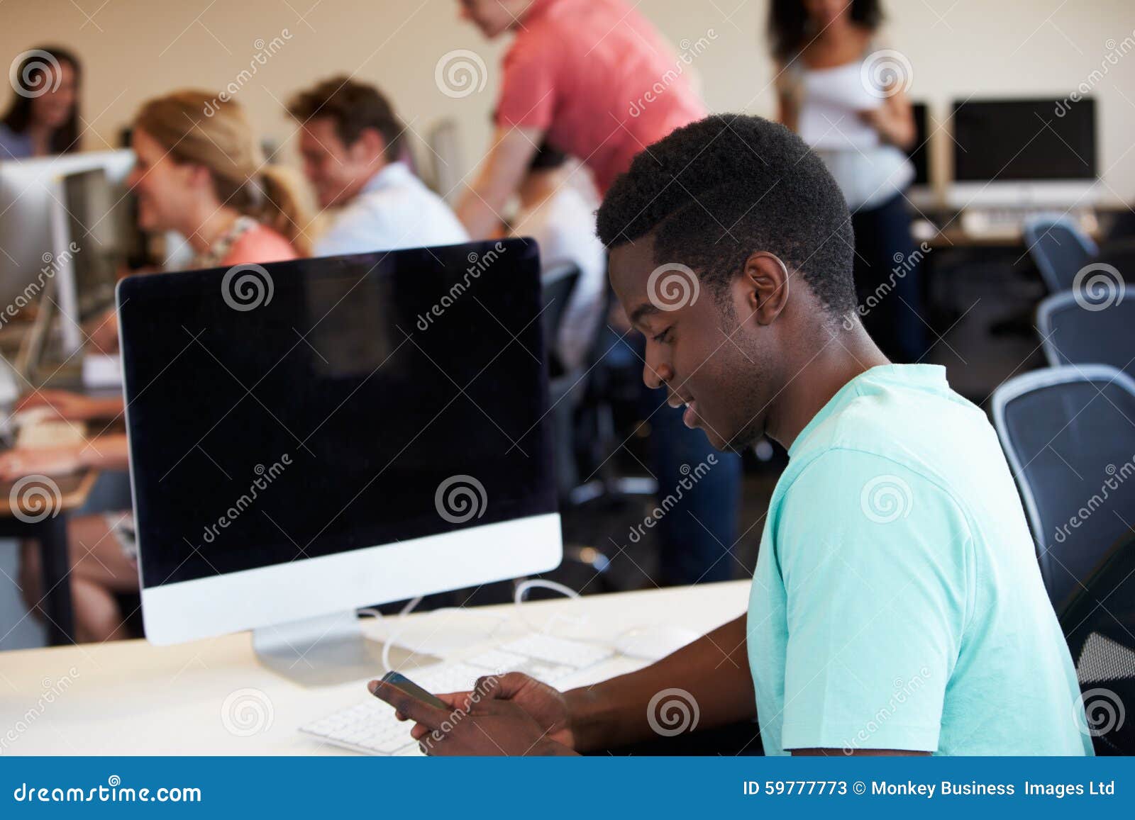 Male College Student Using Mobile Phone in Classroom Stock Image ...