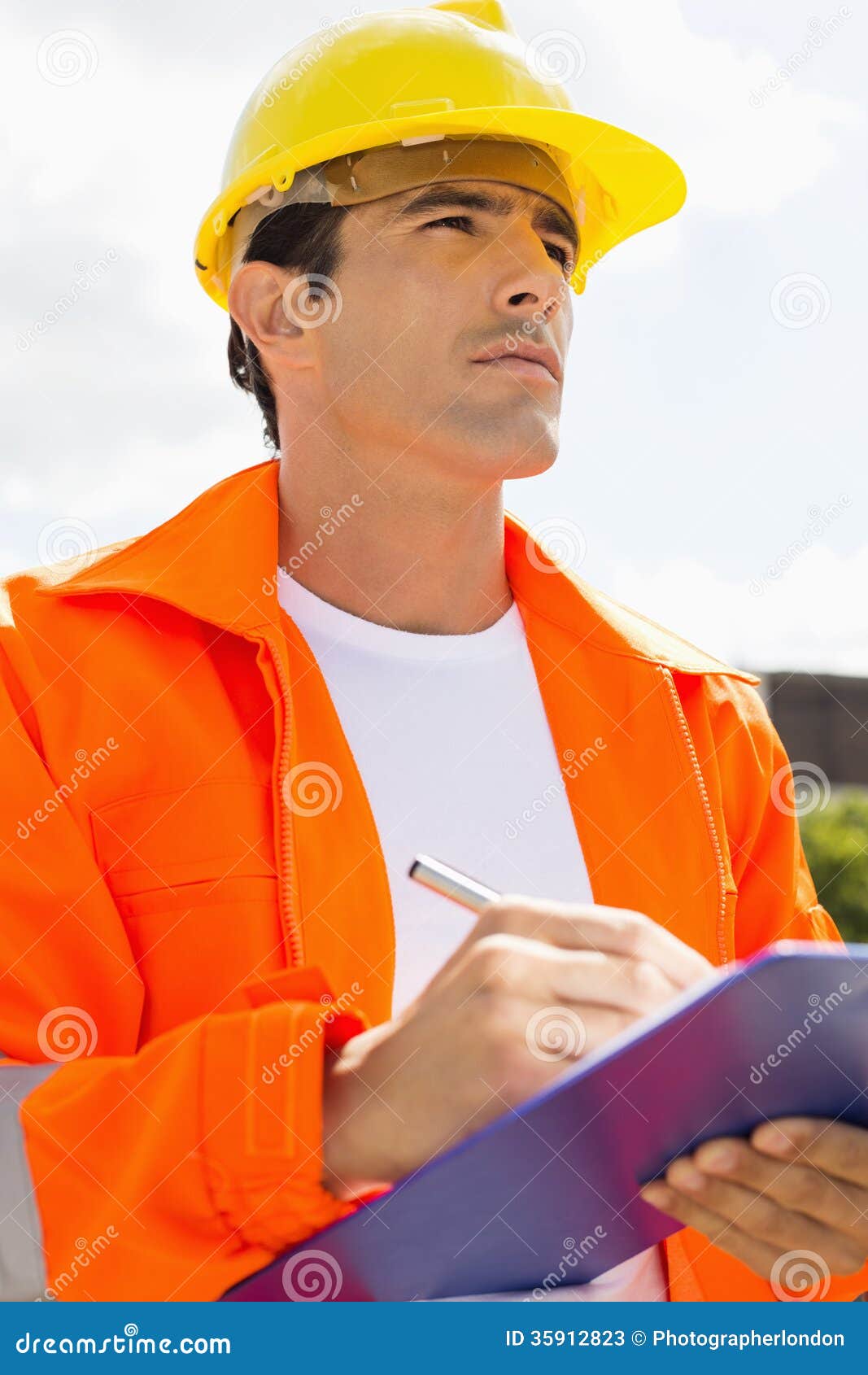 Male Construction Worker with Clipboard Looking Away Outside Stock ...