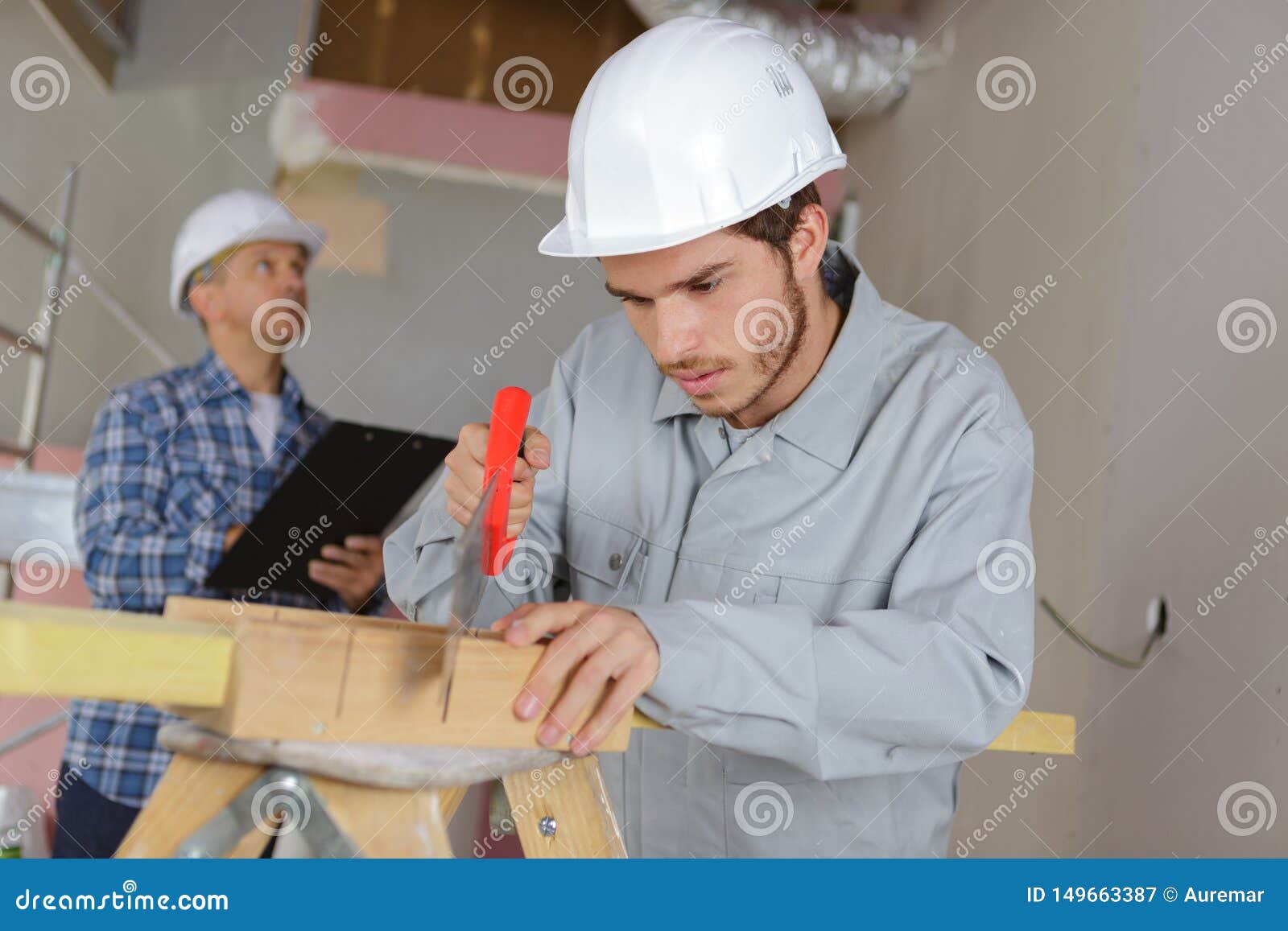Male Construction Worker Cutting Wood with Handsaw Stock Image - Image ...
