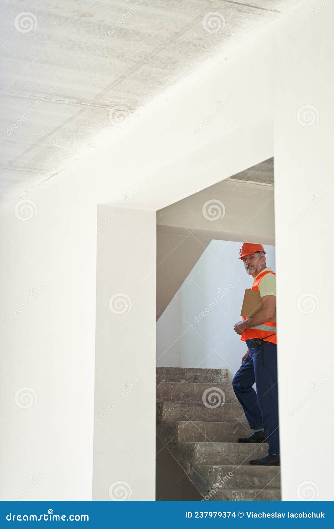 Male Construction Worker Going Up the Stairs with Notepad Stock Photo ...