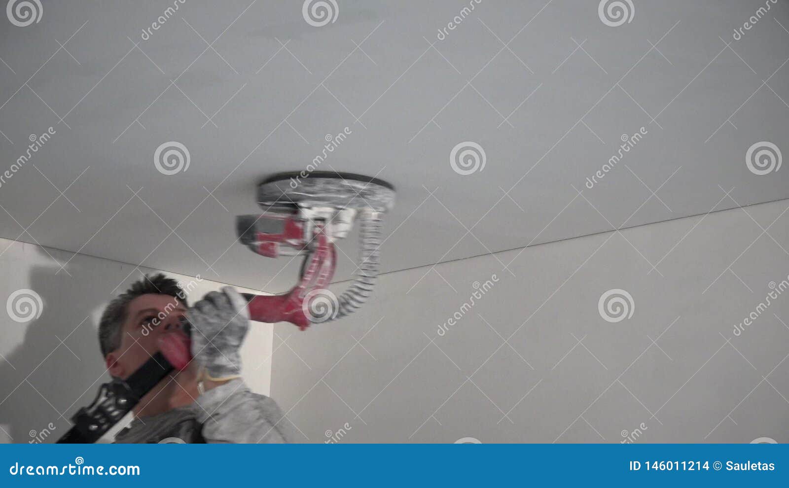 Male Construction Worker Smoothing Ceiling Surface with Sanding Machine ...