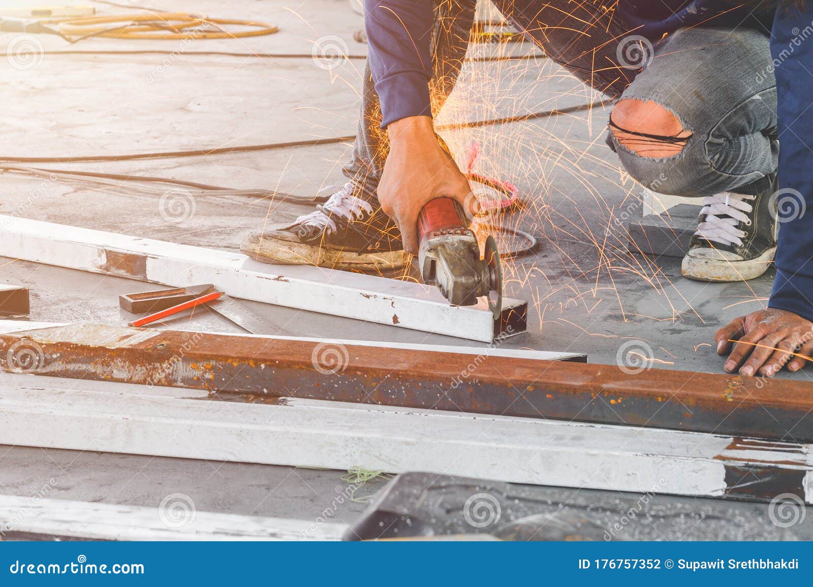 Male Construction Worker Using Electrical Angle Grinder for Cutting ...