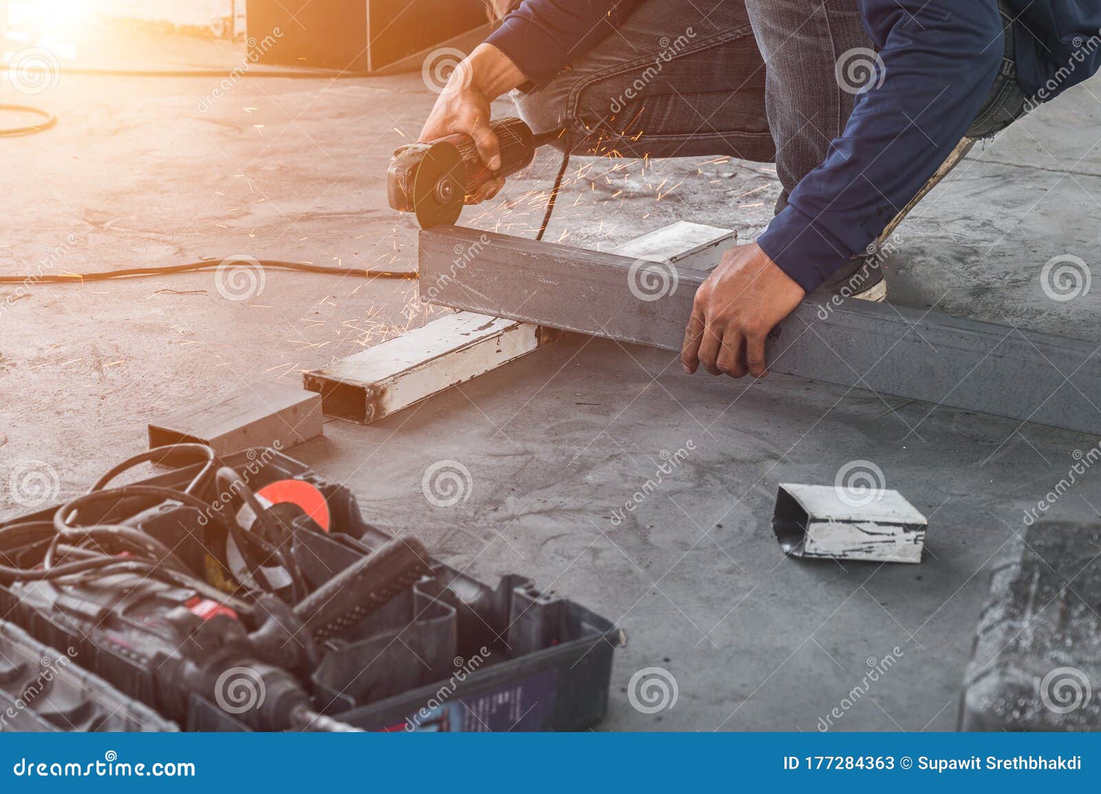 Male Construction Worker Using Electrical Angle Grinder for Cutting ...