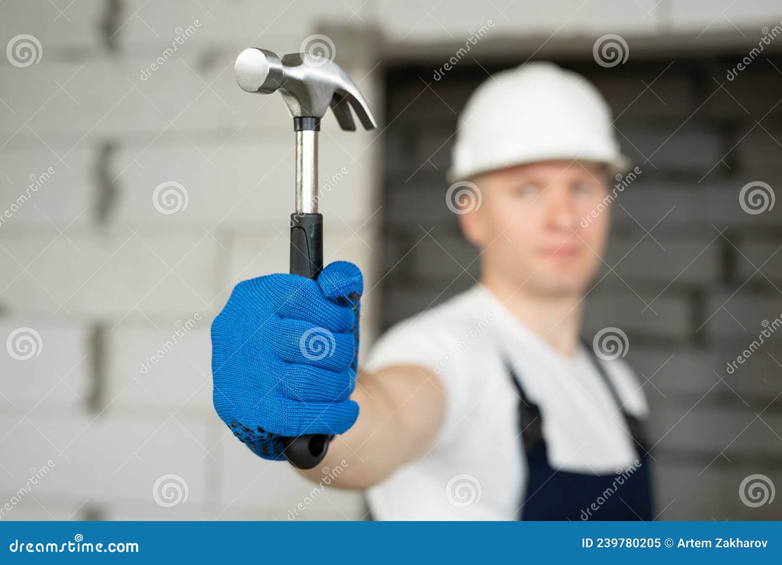 Male Construction Worker Wearing a Helmet with a Hammer. Stock Image ...
