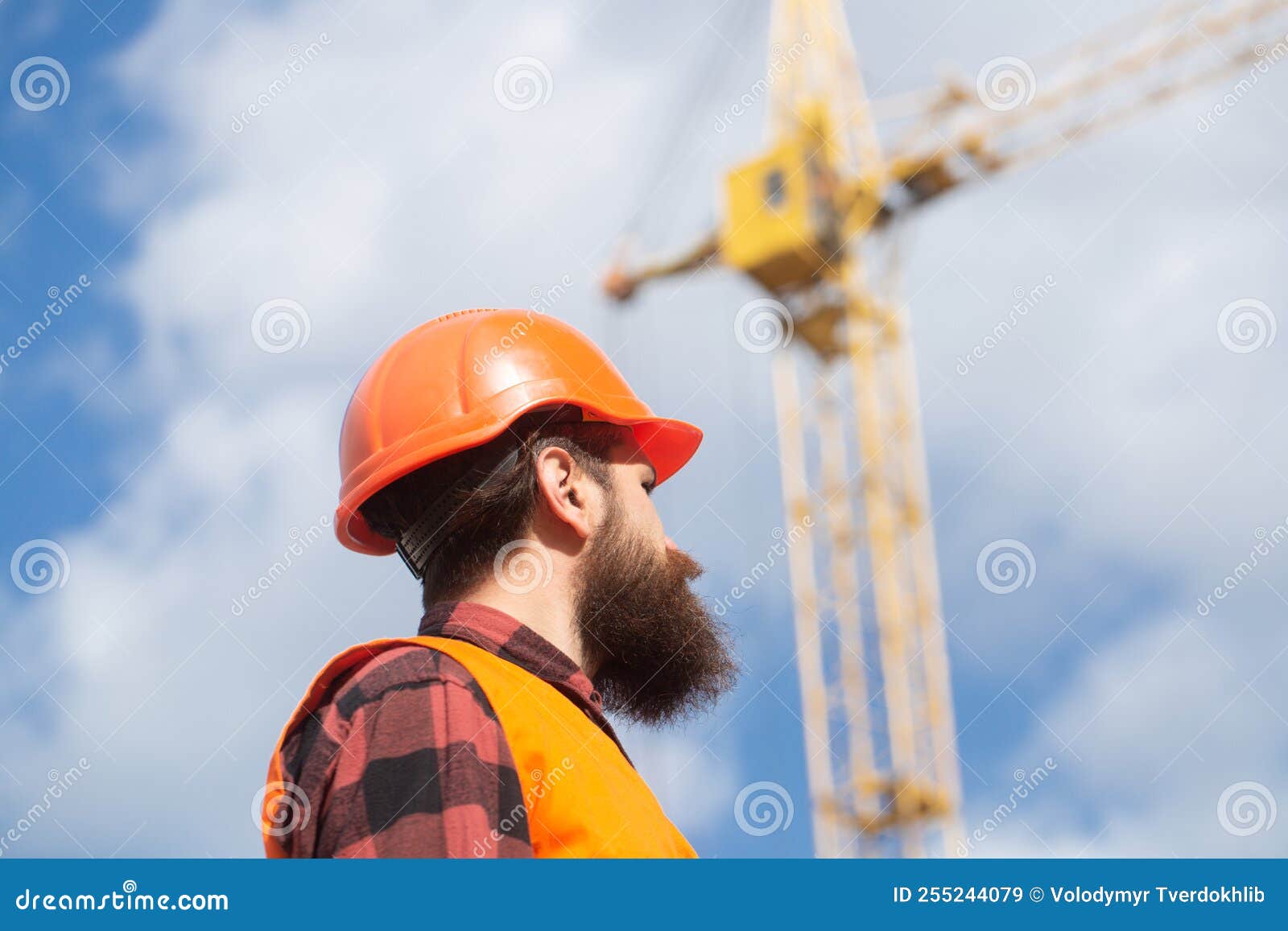 Male Construction Worker in Work Clothes and a Construction Helmet ...