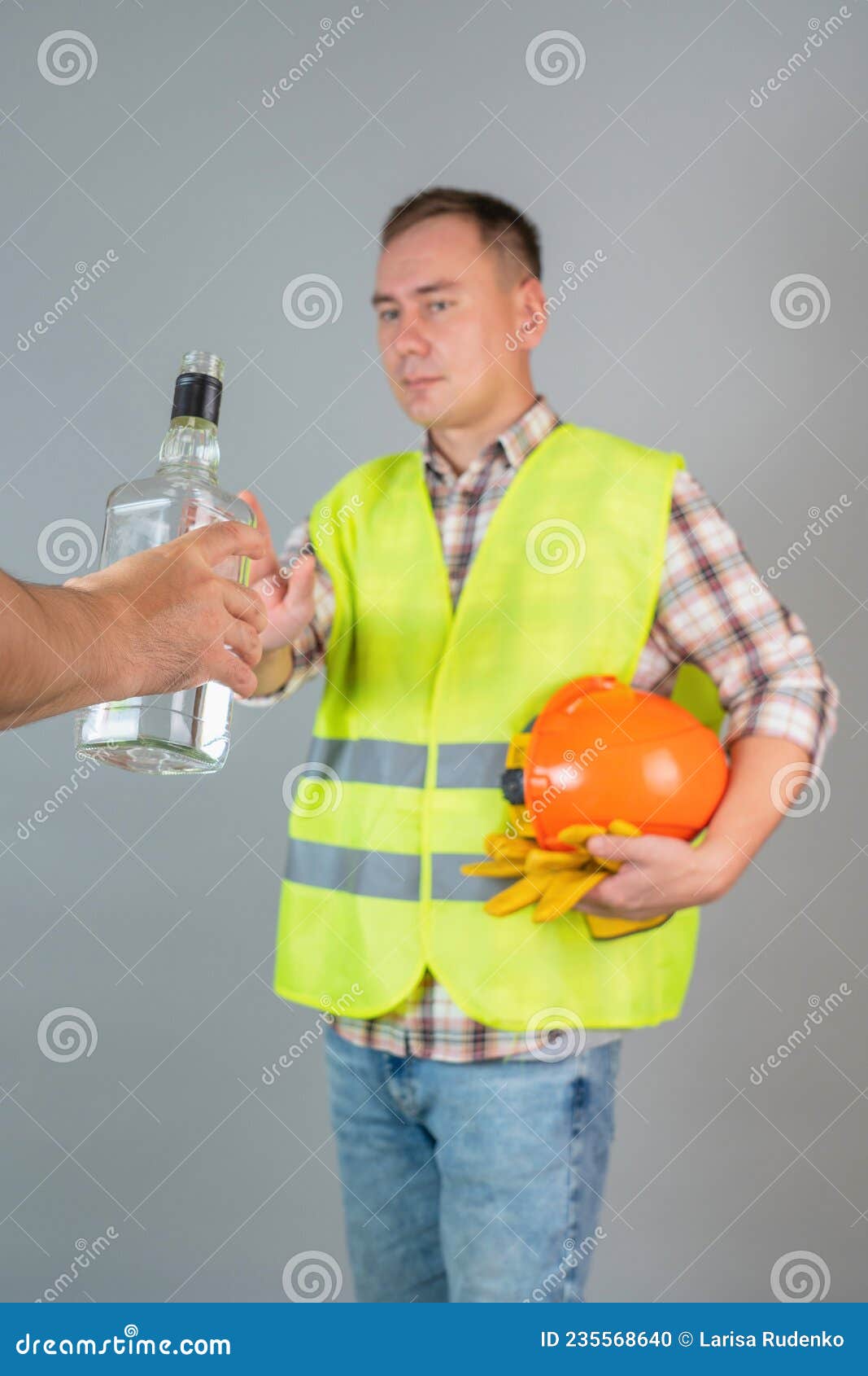 A Male Construction Worker in Work Clothes Refuses a Proffered Bottle ...