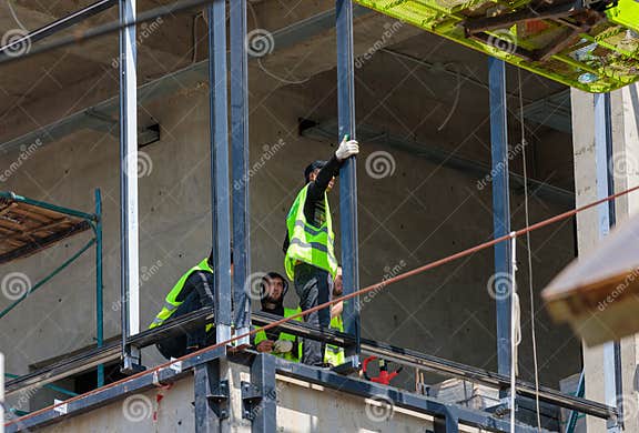 Male Construction Workers are Installing the Iron Frame for the Glazing ...