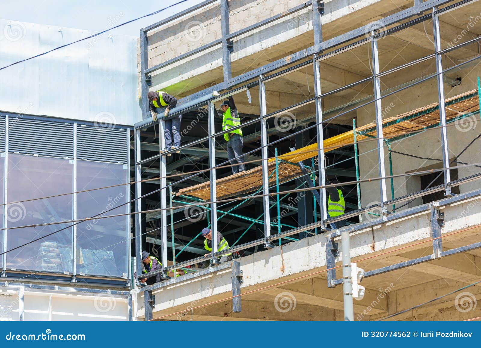 Male Construction Workers are Installing the Iron Frame for the Glazing ...