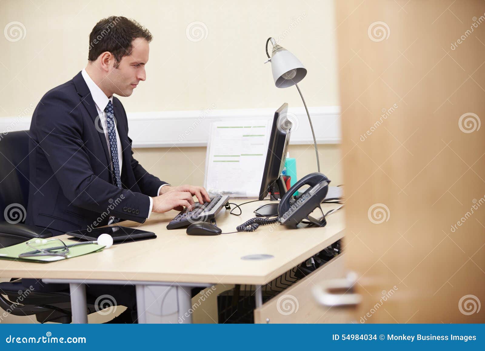 Male Consultant Working at Desk in Office Stock Photo - Image of ...