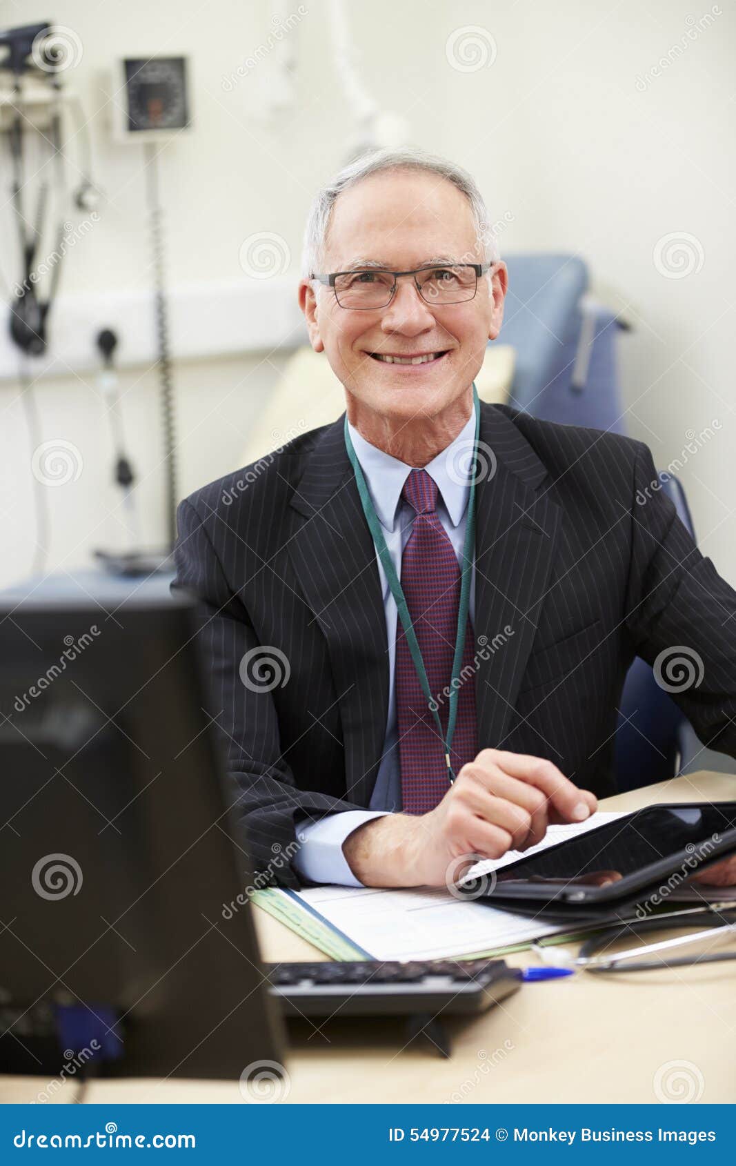 Male Consultant Working at Desk Using Digital Tablet Stock Photo ...