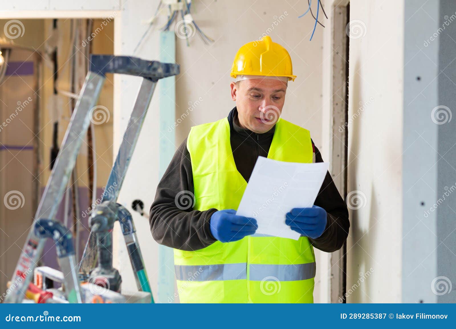 Male Contractor Looking at Room and Determining Scope of Building Work ...