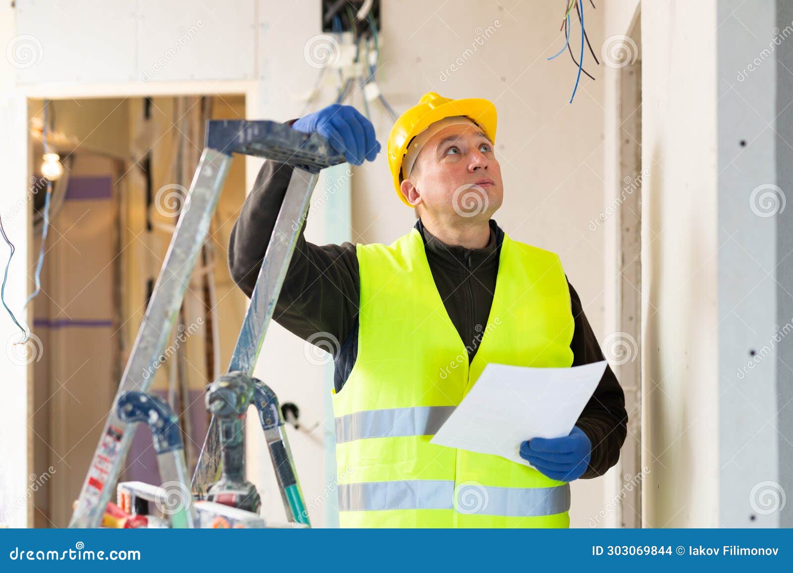 Male Contractor Looking at Room and Determining Scope of Building Work ...