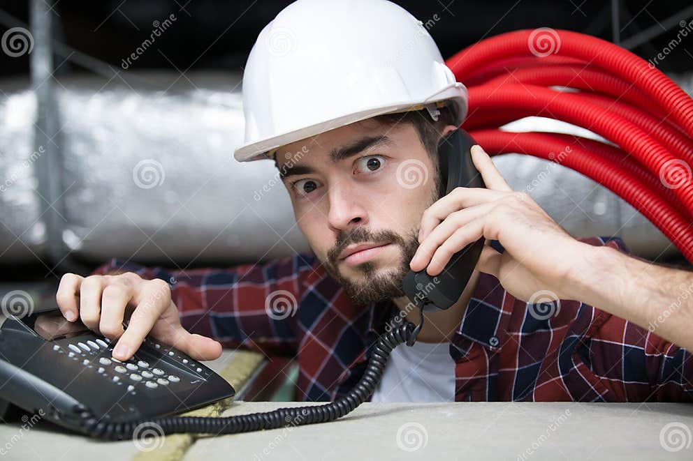 Male Contractor Making Strange Expression while Using Telephone Stock ...