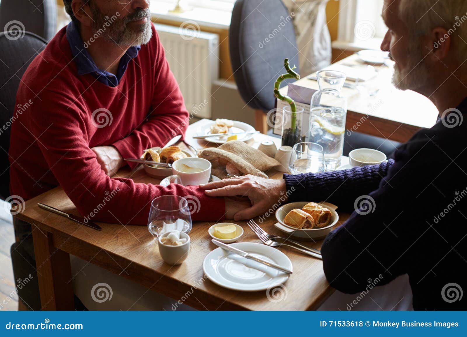 Male Couple Hold Hands at a Restaurant Table, Elevated View Stock Photo ...