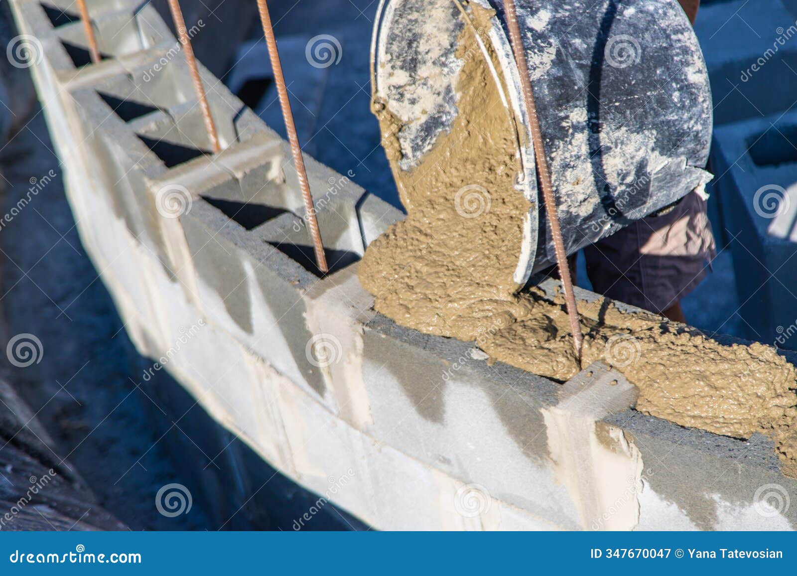 Male Craftsman Pouring Concrete into Concrete Bricks. Selective Focus ...