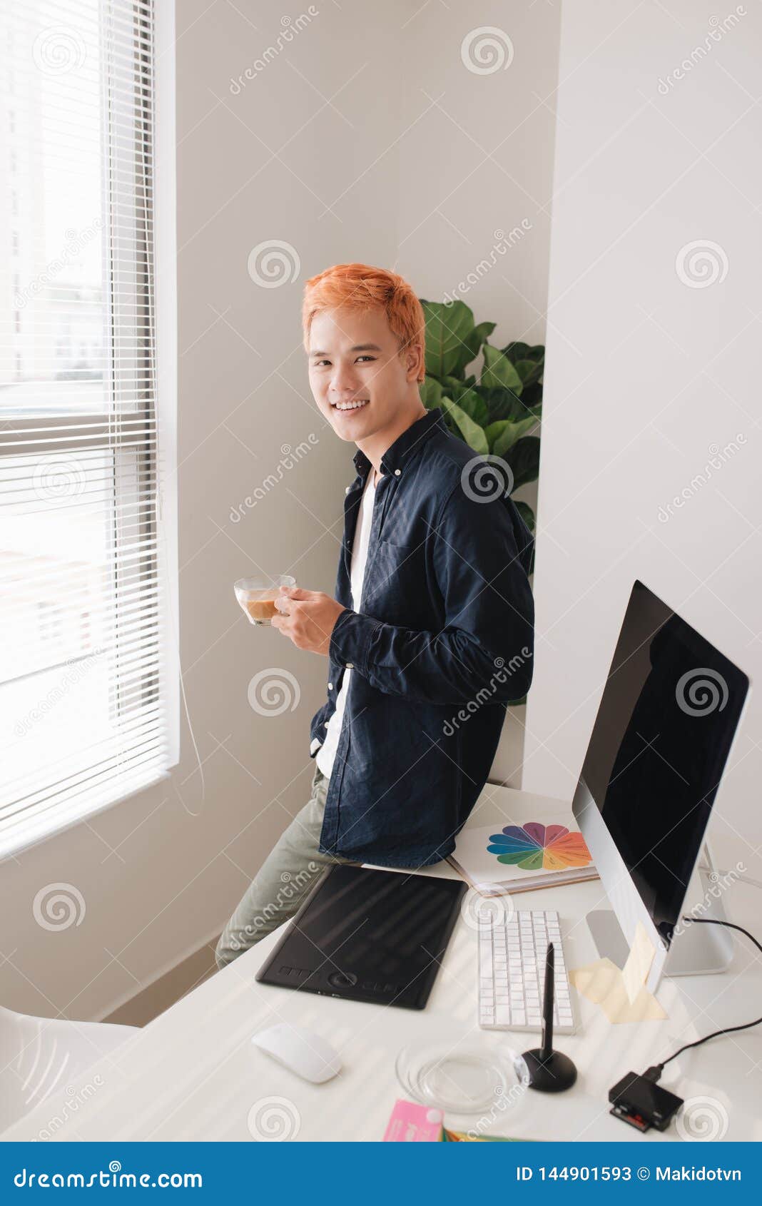 Male Creative Worker Standing in Front of Desk in the Creative Office ...