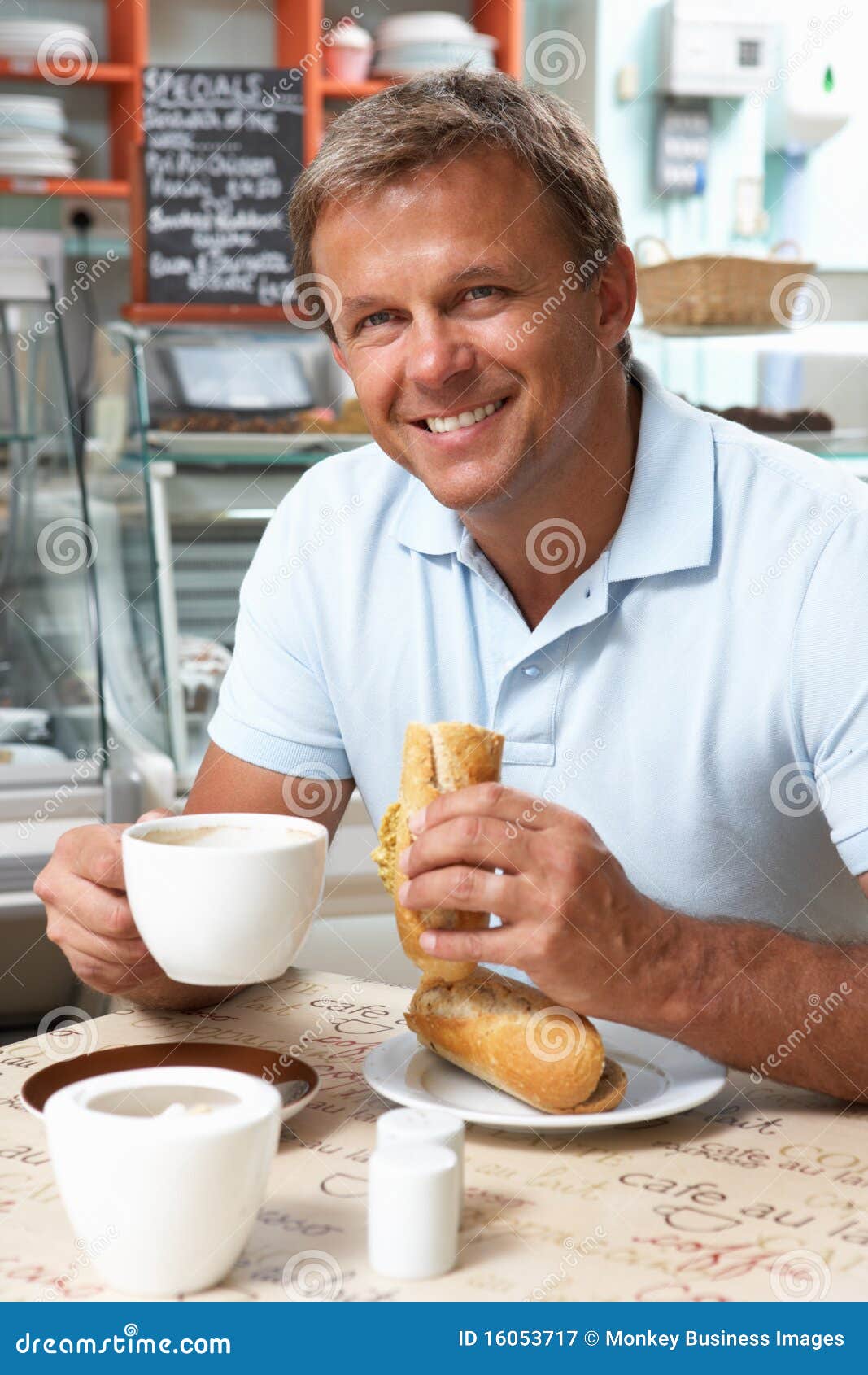 Male Customer Enjoying Sandwich and Coffee in Cafe Stock Image - Image ...