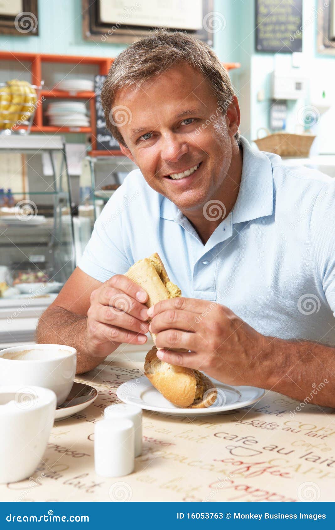 Male Customer Enjoying Sandwich and Coffee in Cafe Stock Image - Image ...