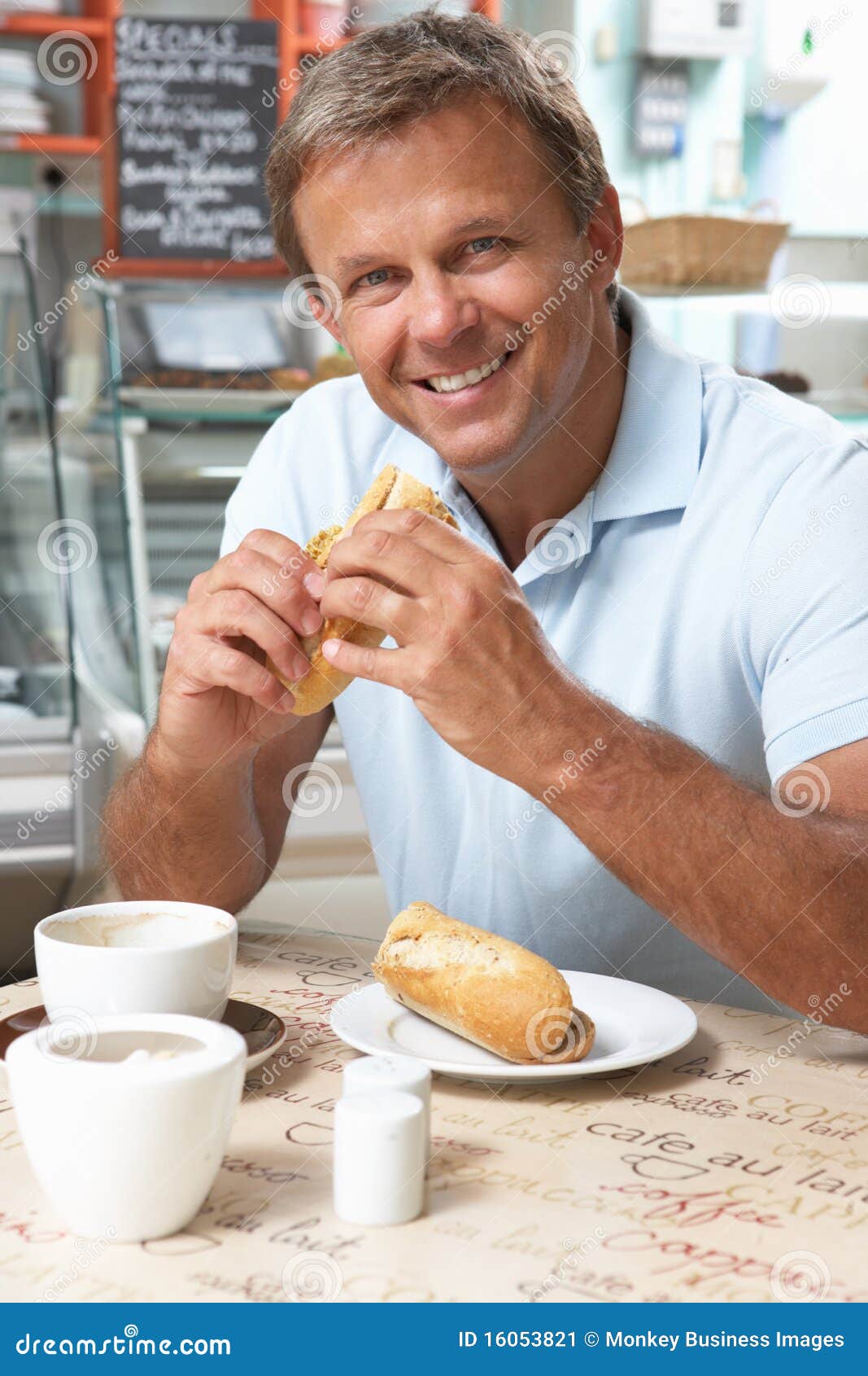 Male Customer Enjoying Sandwich and Coffee in Cafe Stock Image - Image ...