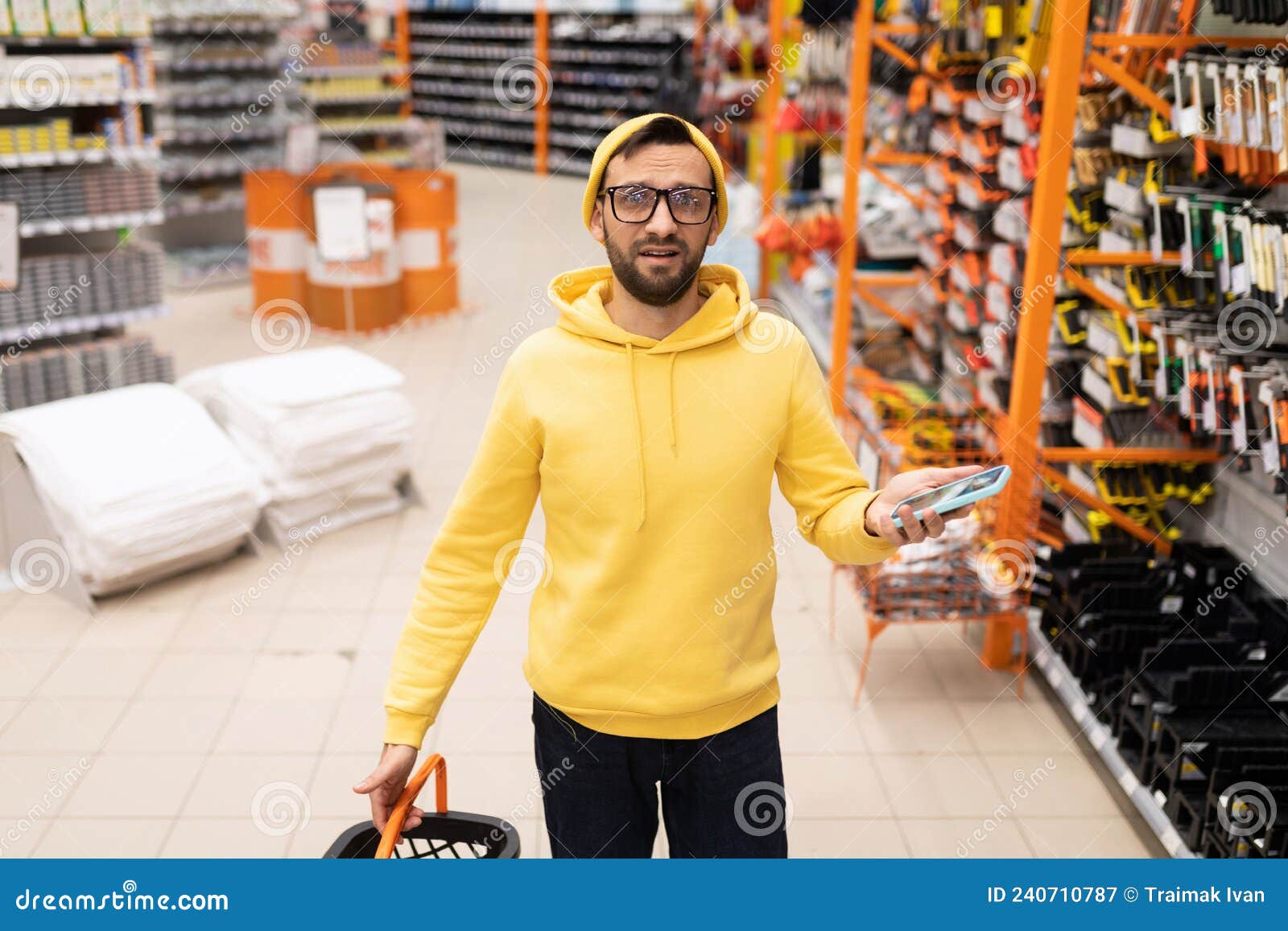 A Male Customer is Lost in a Hardware Store among a Wide Range of Goods ...