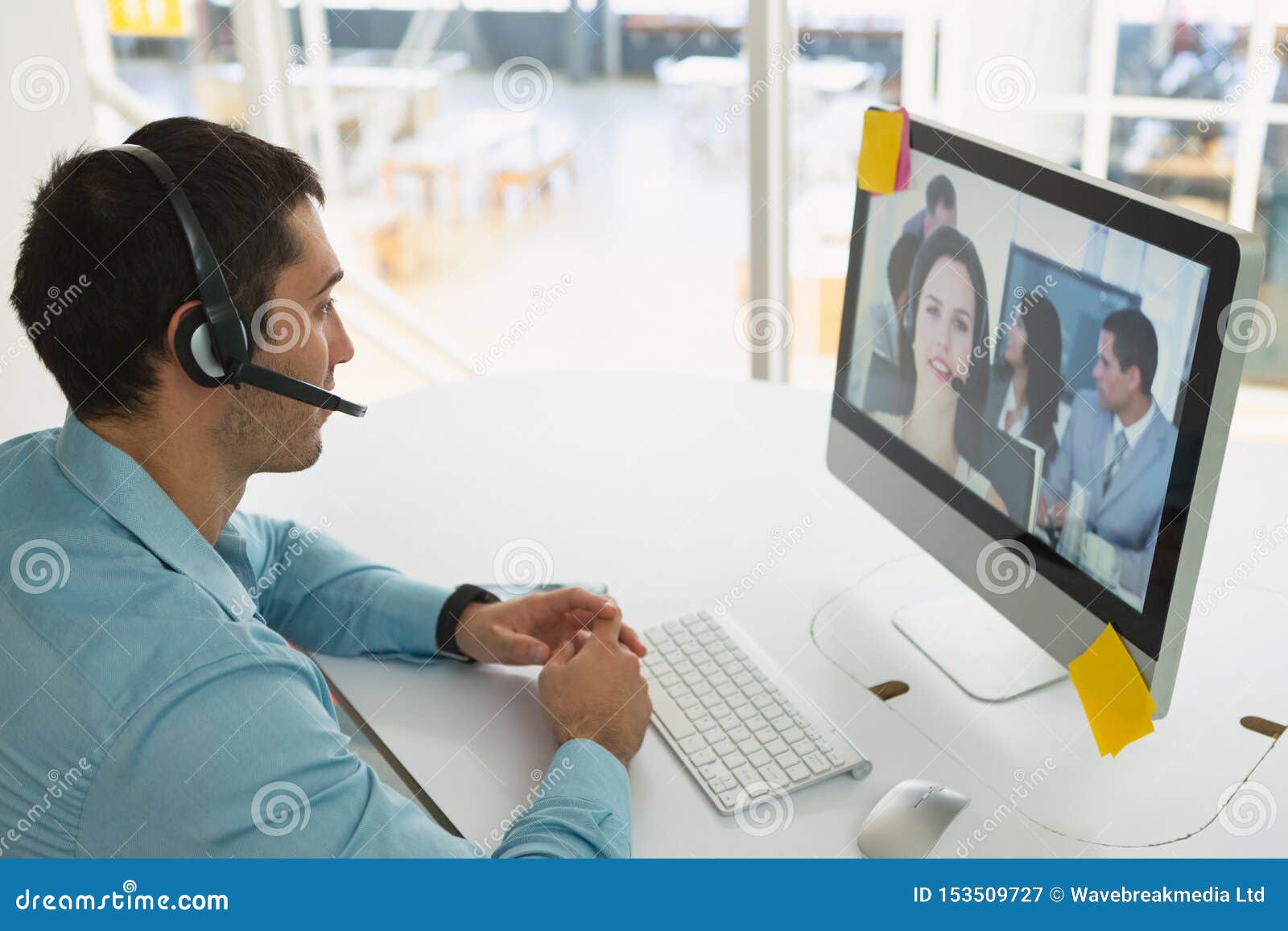 Male Customer Service Executive Making Video Call on Computer at Desk ...