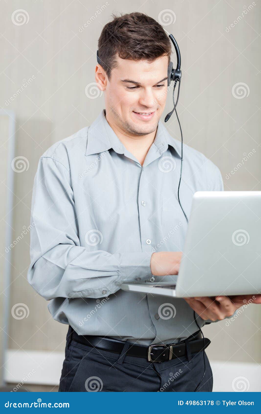 Male Customer Service Representative Using Laptop Stock Photo - Image ...