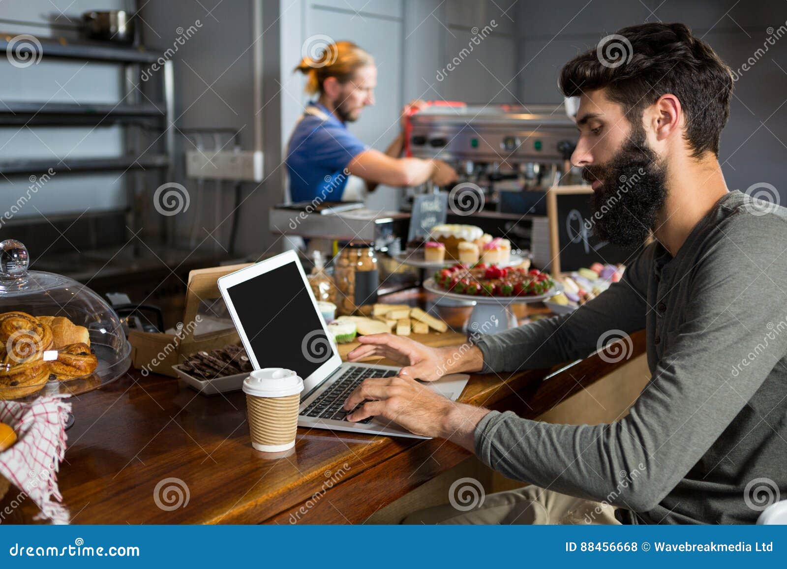 Male Customer Using Laptop while Having Coffee at Counter Stock Photo ...