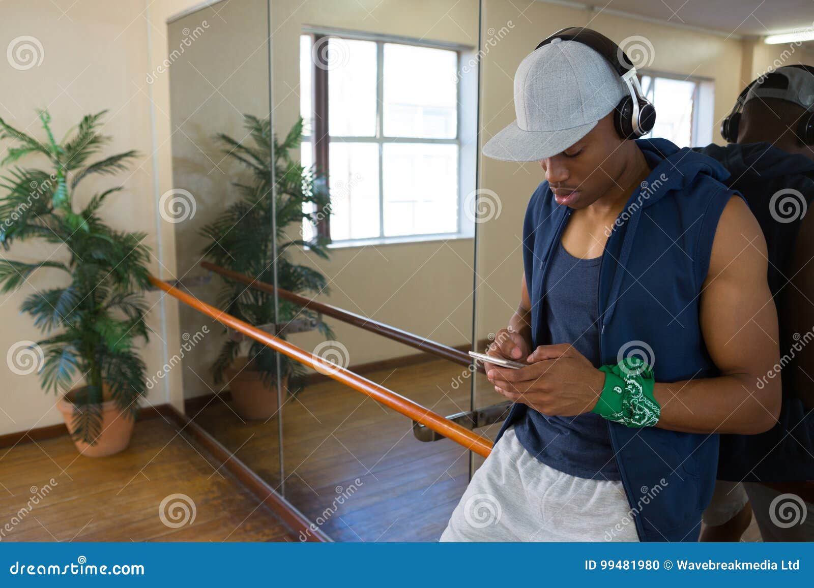 Male Dancer Using Phone in Studio Stock Photo - Image of plant, message ...