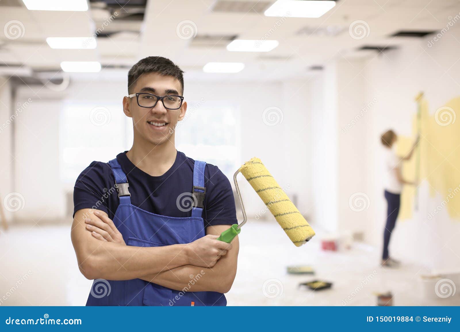 Male Decorator with Paint Roller Indoors Stock Photo - Image of ...