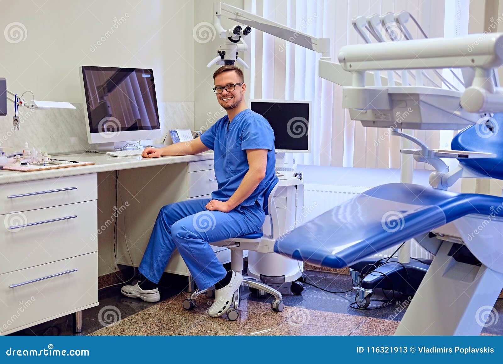 Dentist Looking at Teeth X-ray on the Computer in a Dentist Office ...