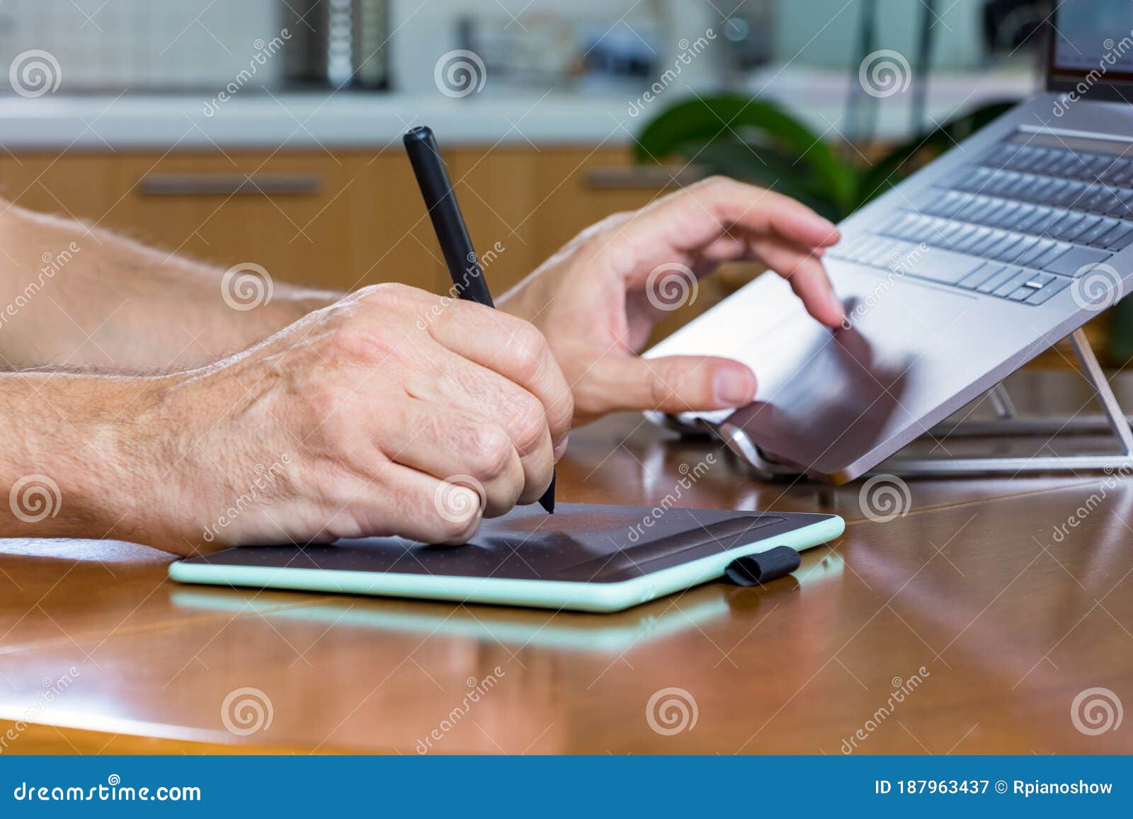 Male Designer Hands Using a Drawing Graphics Tablet and a Laptop while ...