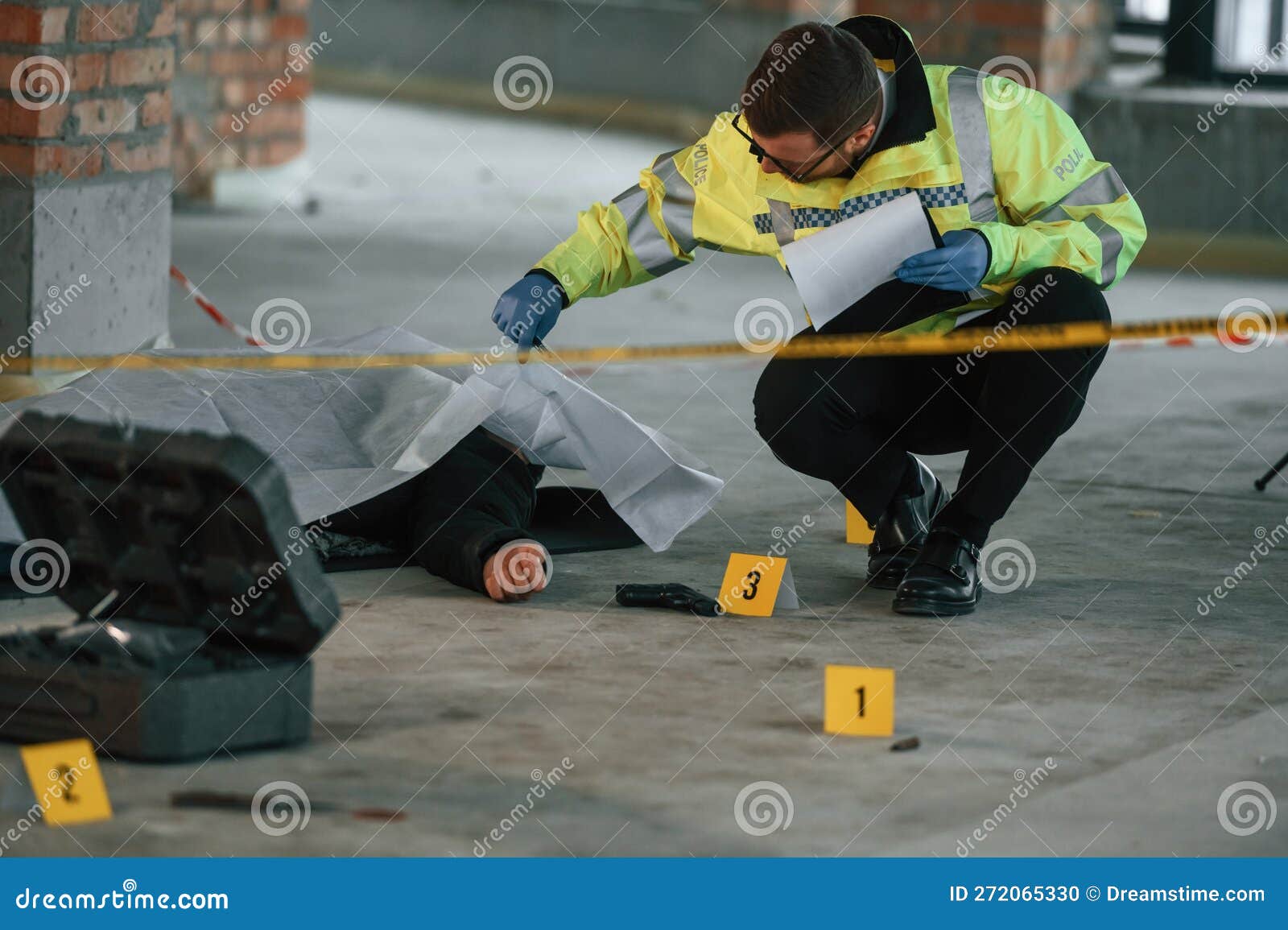 Male Detective Is Collecting Evidence In A Crime Scene Near Dead Body