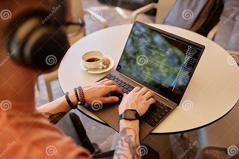 Male it Developer Using Laptop Writing Code while Working at Cafe Table ...