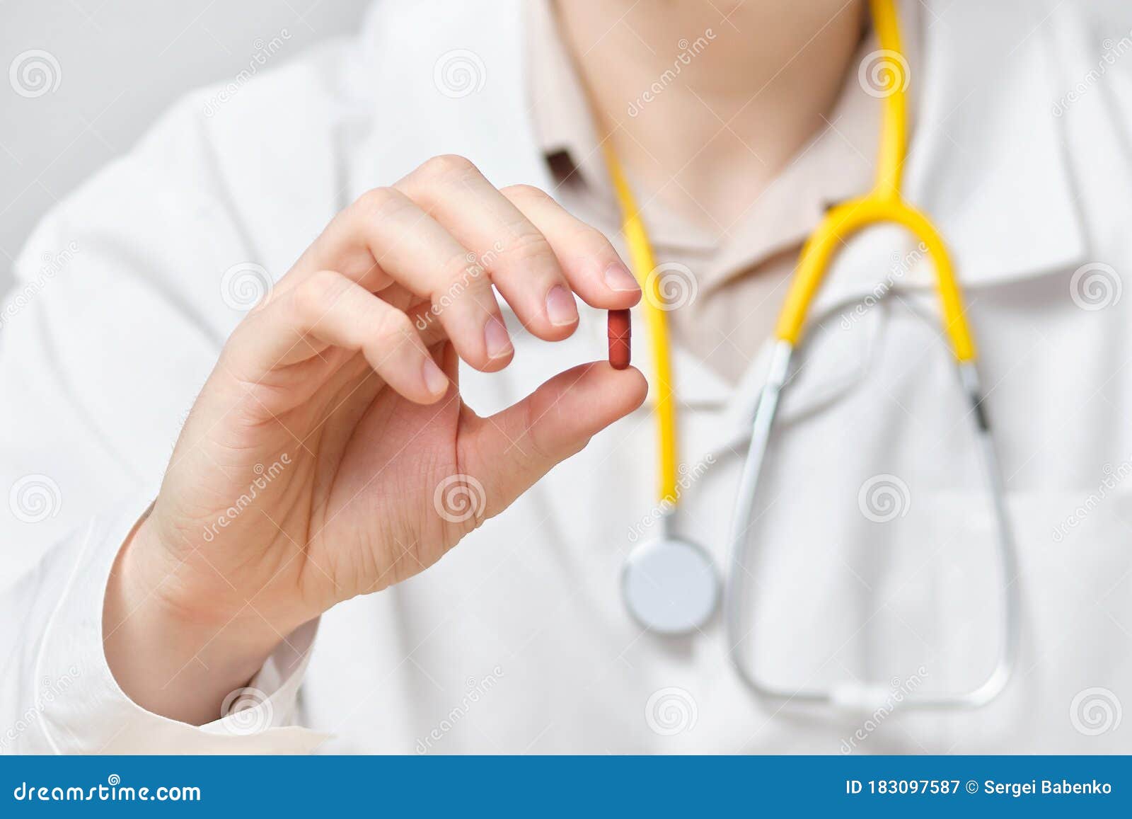 A Male Doctor Is Holding A Medicine In The Form Of A Pill Stock Image