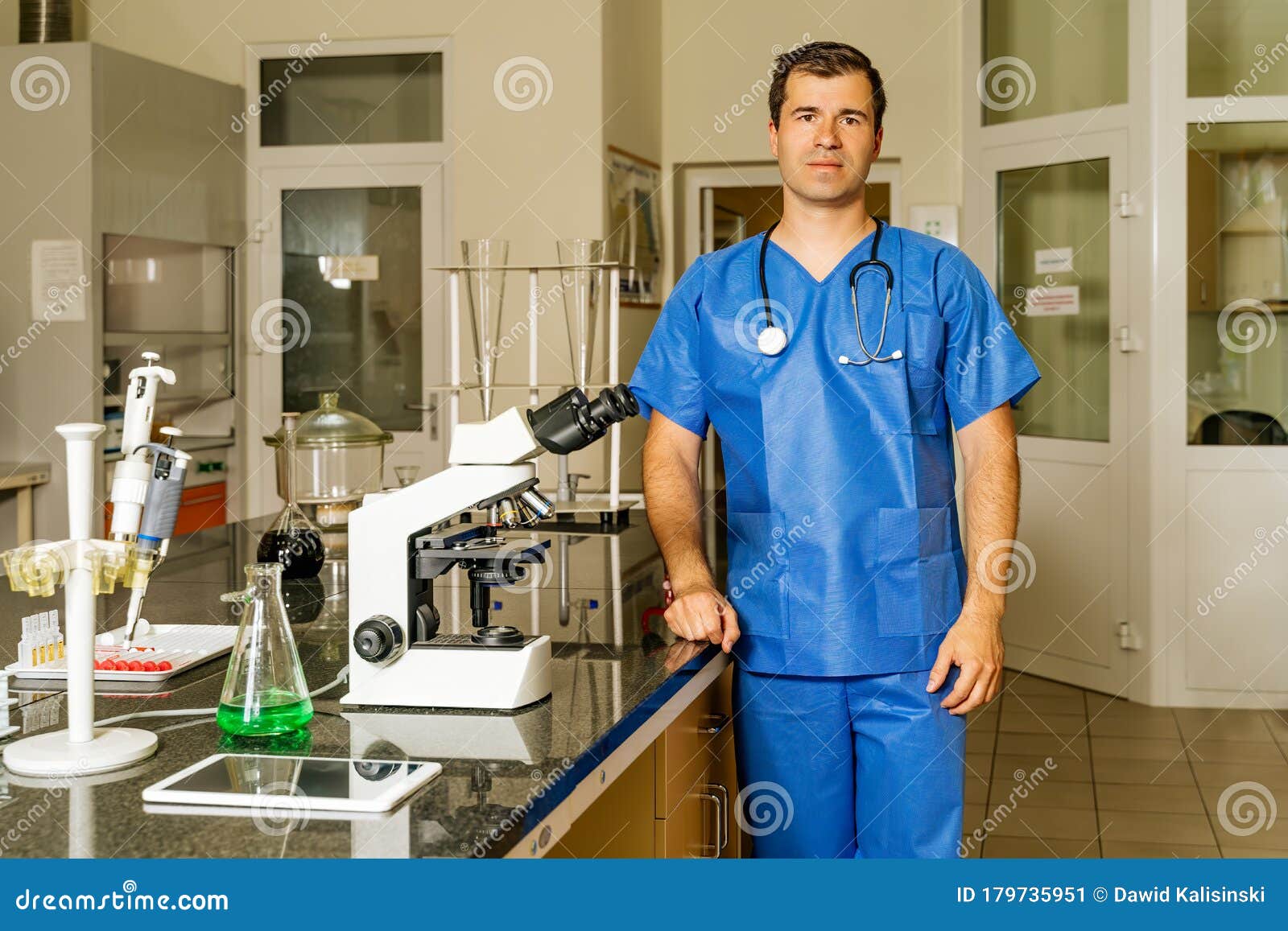 Male Doctor Researching Covid 19 Virus Samples Under Microscope Stock ...