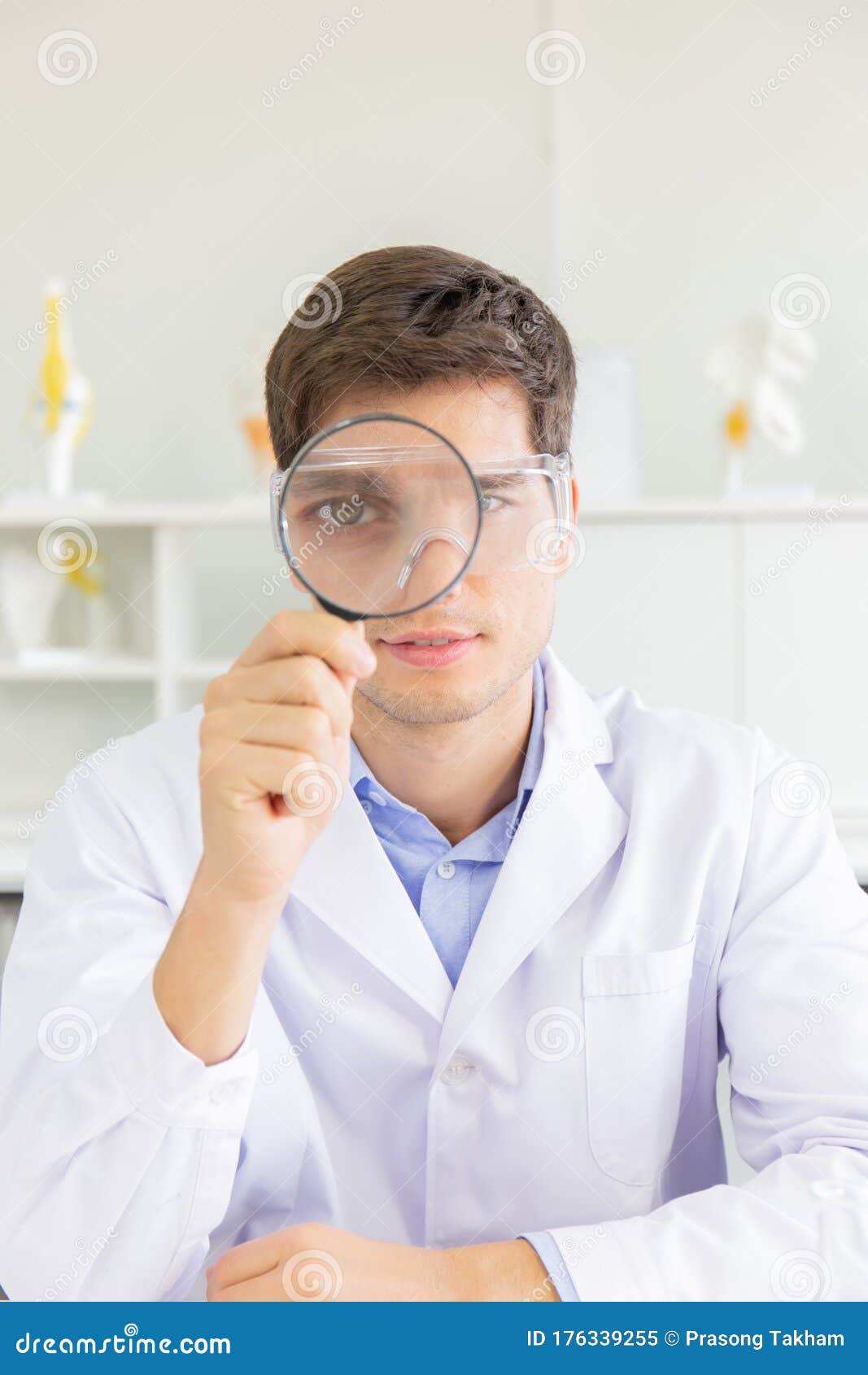 Male Doctor Looking through the Magnifying Glass in the Lab Stock Image ...