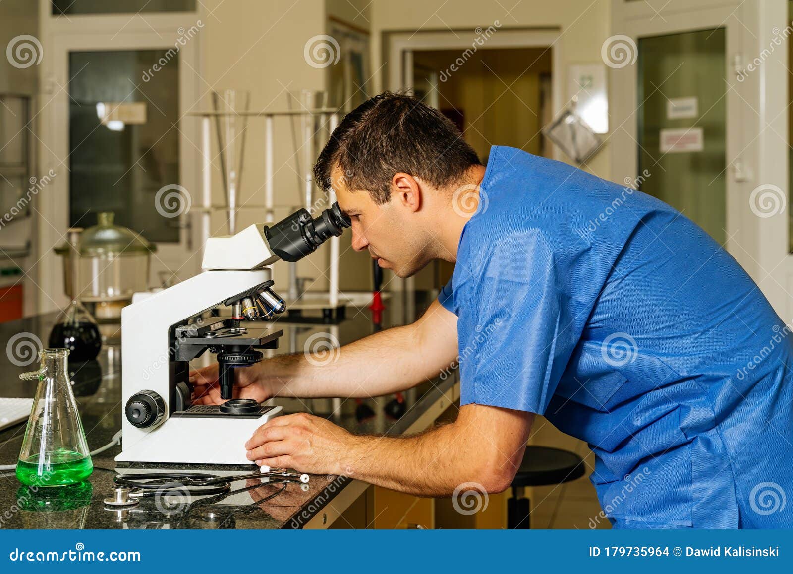 Male Doctor Researching Covid 19 Virus Samples Under Microscope Stock ...