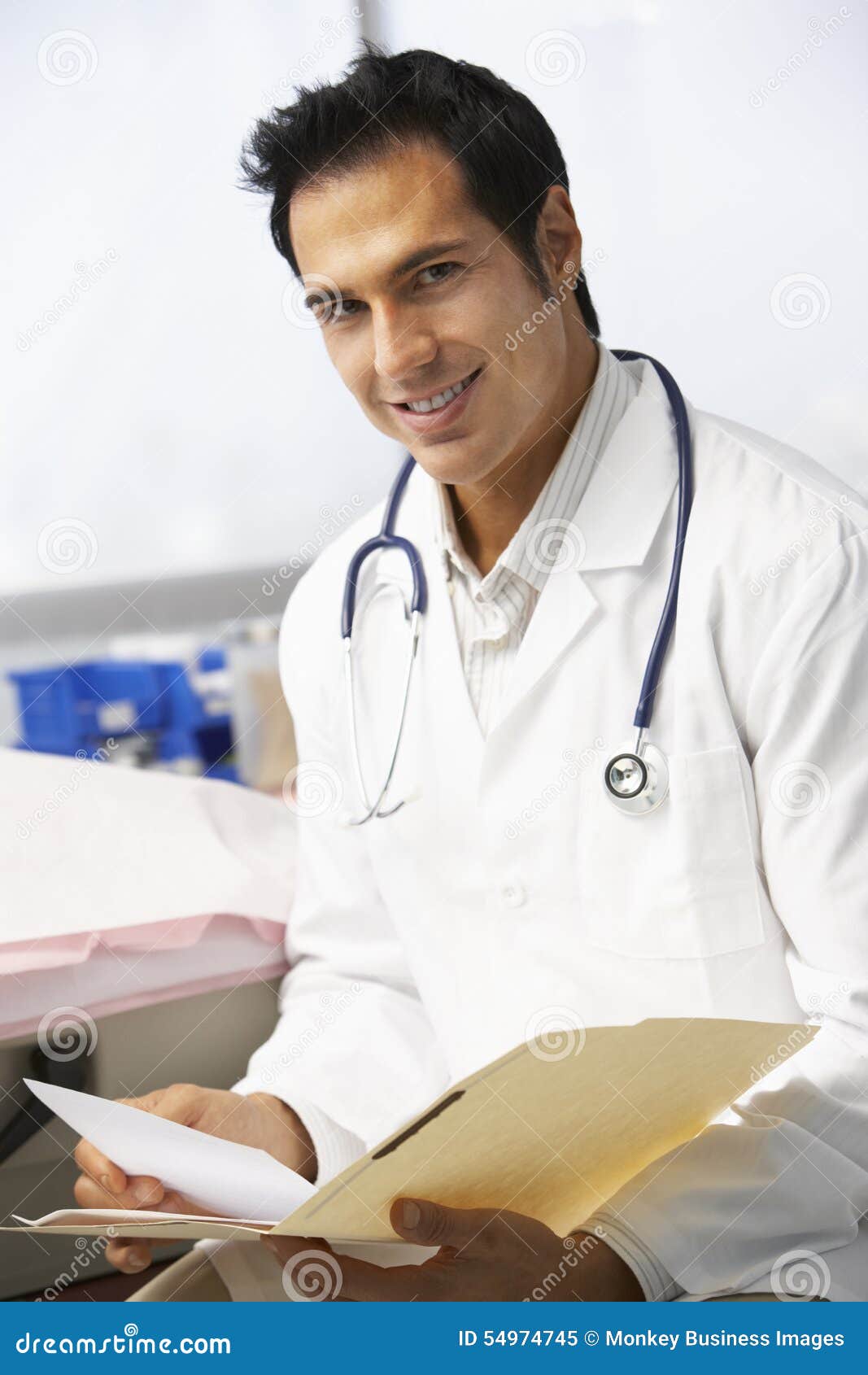 Male Doctor in Surgery Reading Patient Notes Stock Image - Image of ...