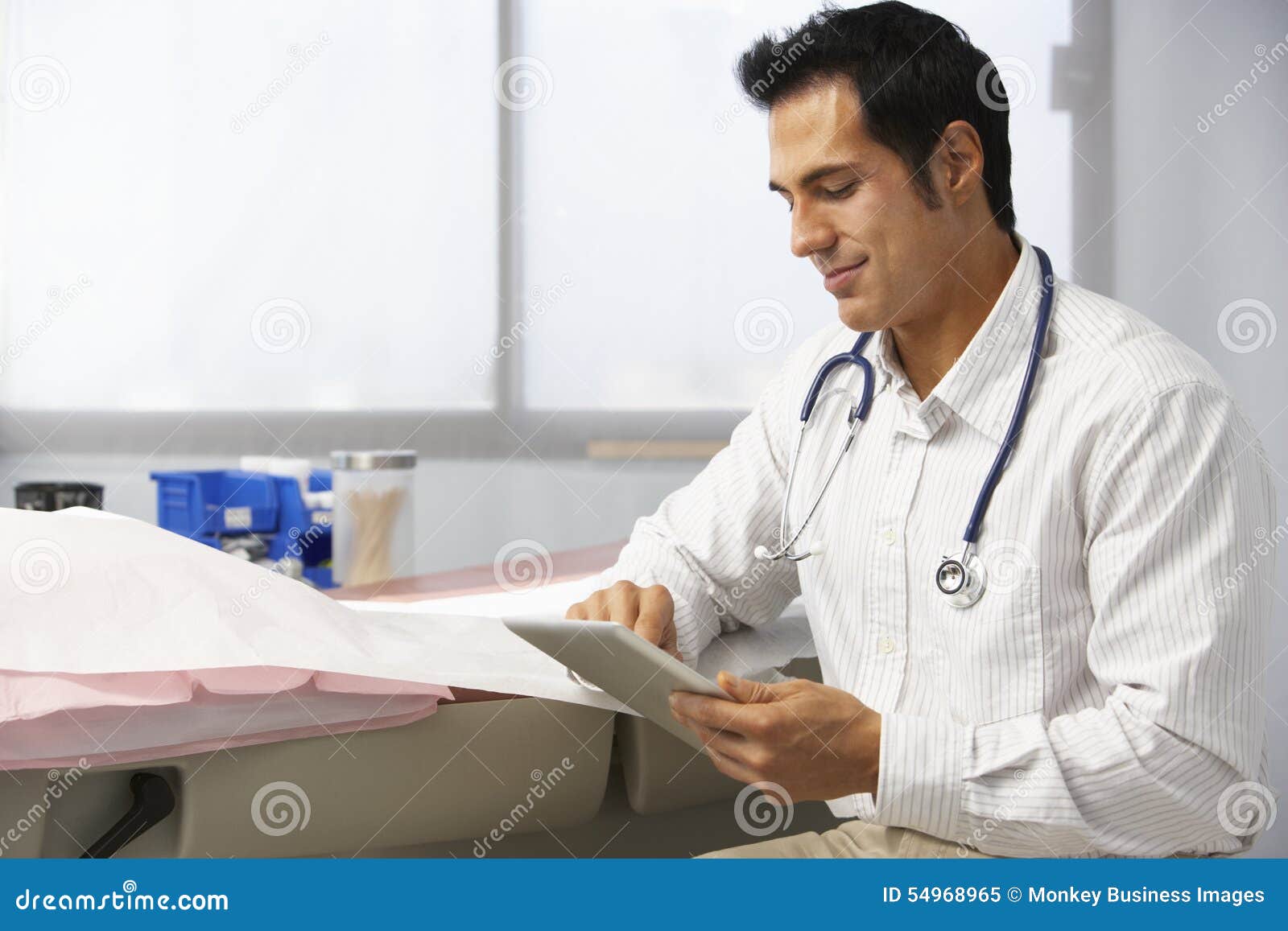 Male Doctor in Surgery Using Digital Tablet Stock Image - Image of ...