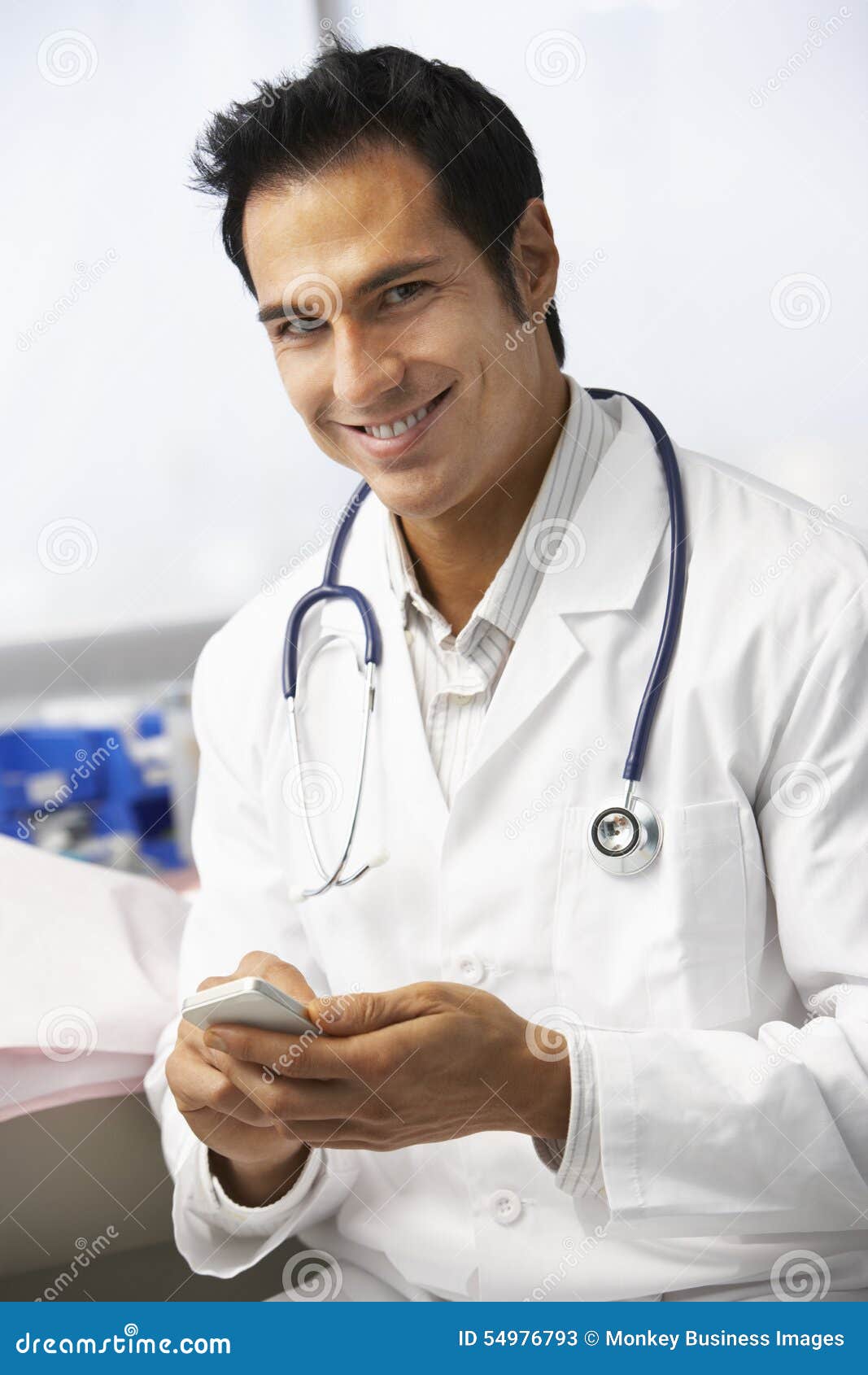 Male Doctor in Surgery Using Mobile Phone Stock Image - Image of office ...